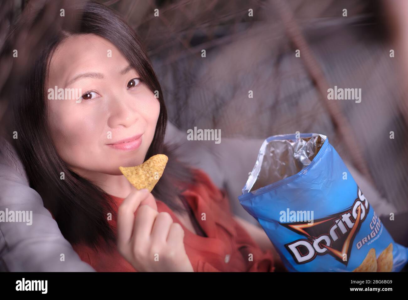 Beautiful asian woman sitting on rattan wicker chair on balcony smiling ...