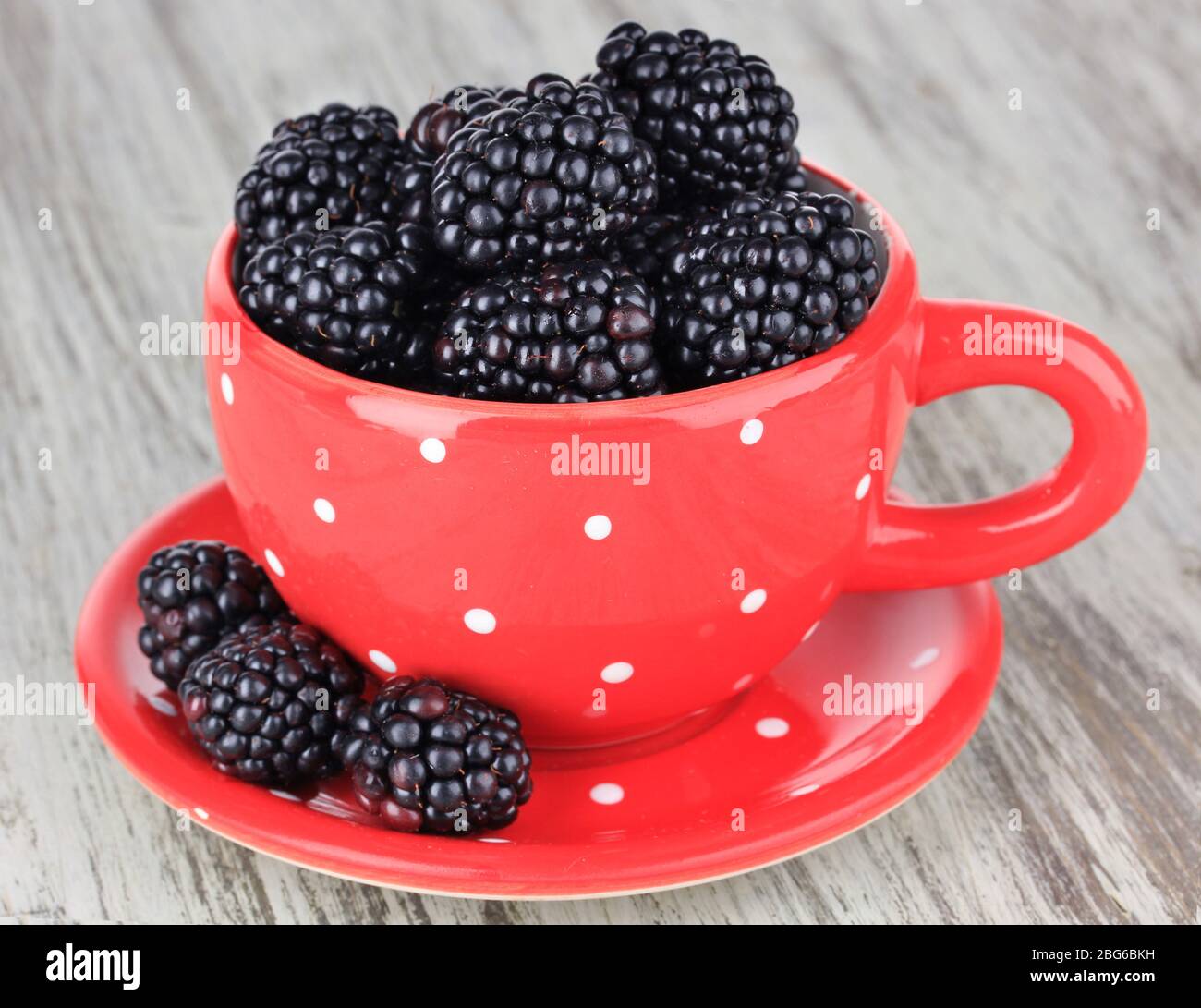 Sweet blackberries in cup on table close-up Stock Photo - Alamy