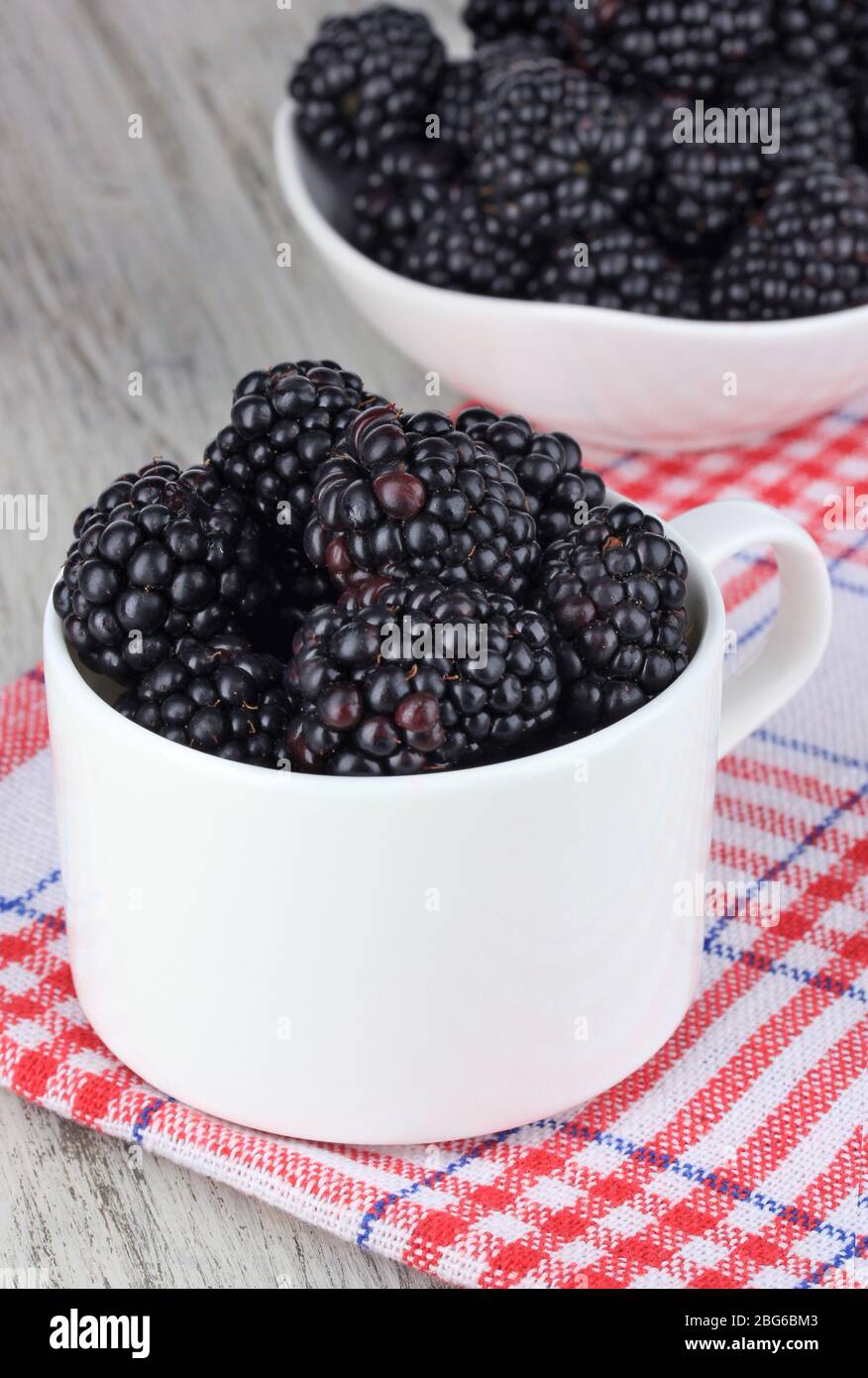 Sweet blackberries in cup on table close-up Stock Photo - Alamy