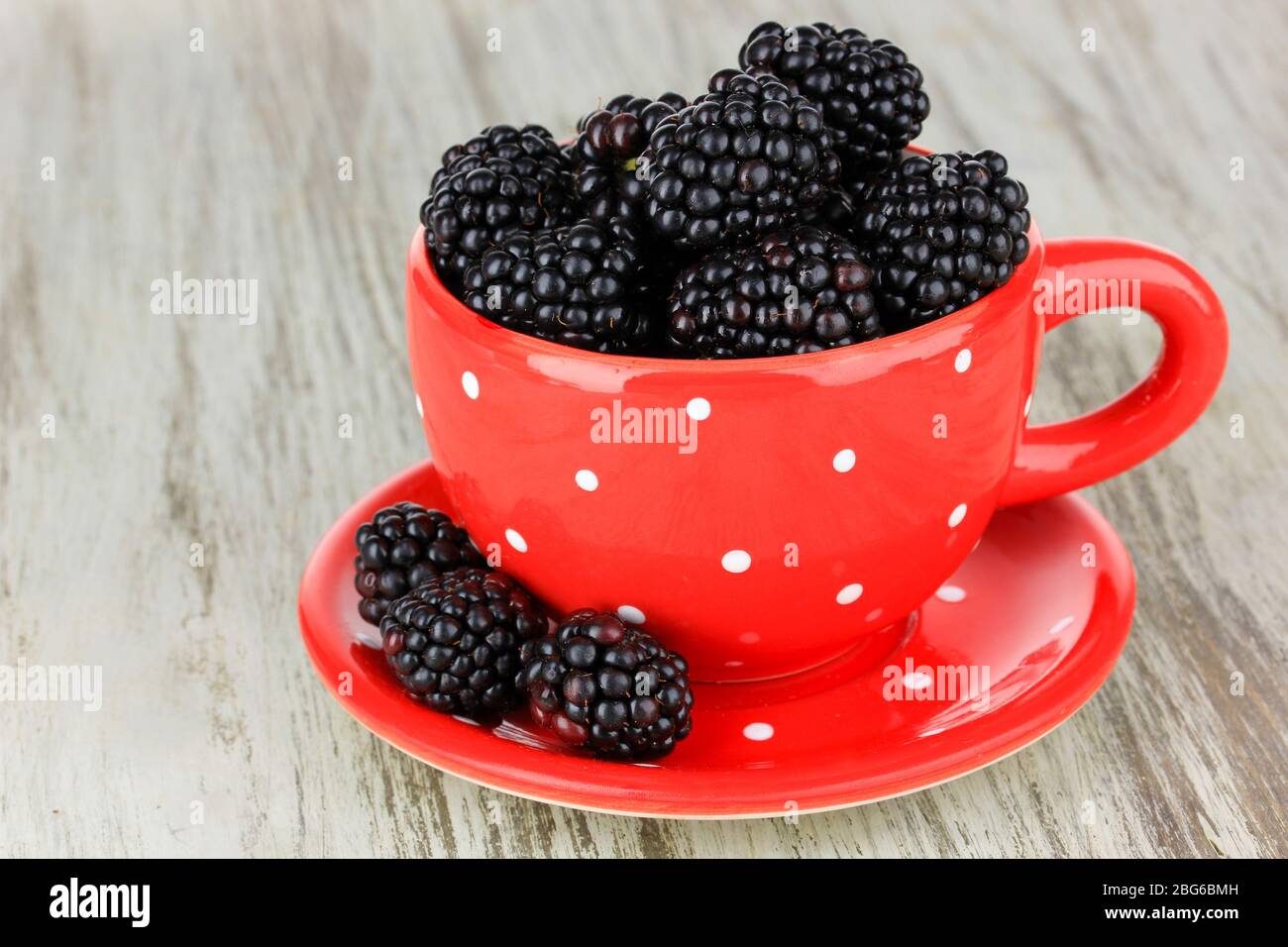 Sweet blackberries in cup on table close-up Stock Photo - Alamy