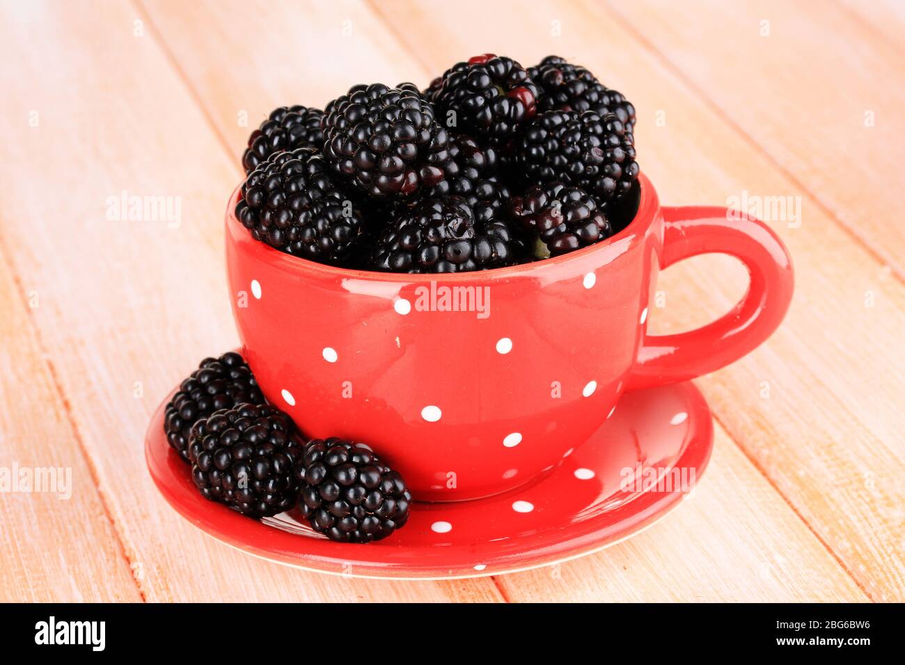 Sweet blackberries in cup on table close-up Stock Photo - Alamy