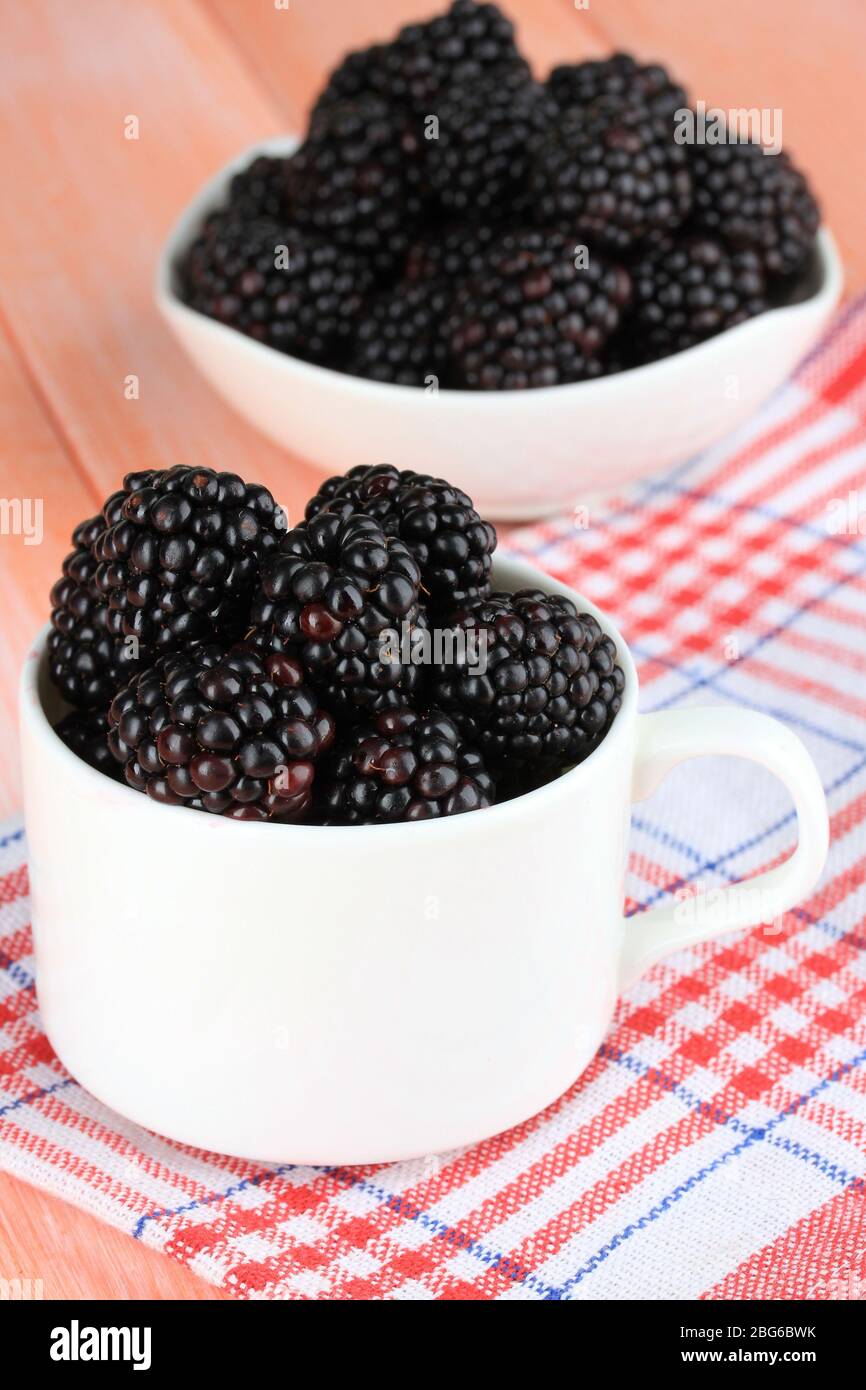 Sweet blackberries in cup on table close-up Stock Photo - Alamy