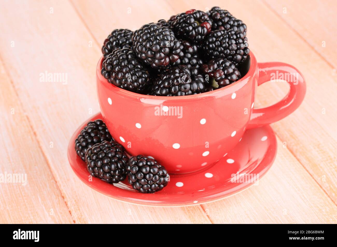 Sweet blackberries in cup on table close-up Stock Photo - Alamy