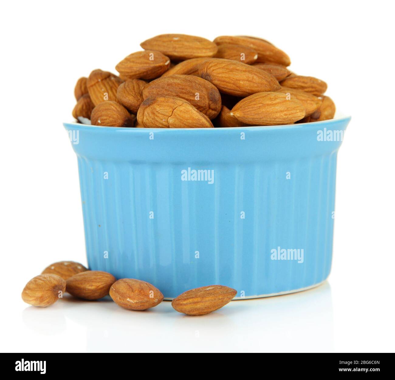 Almond in bowl, isolated on white Stock Photo - Alamy