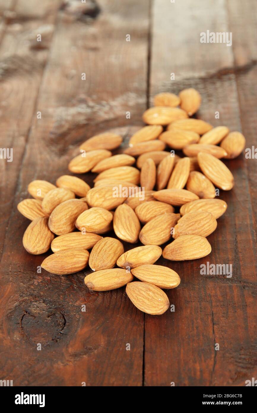 Almond on dark wooden background Stock Photo - Alamy