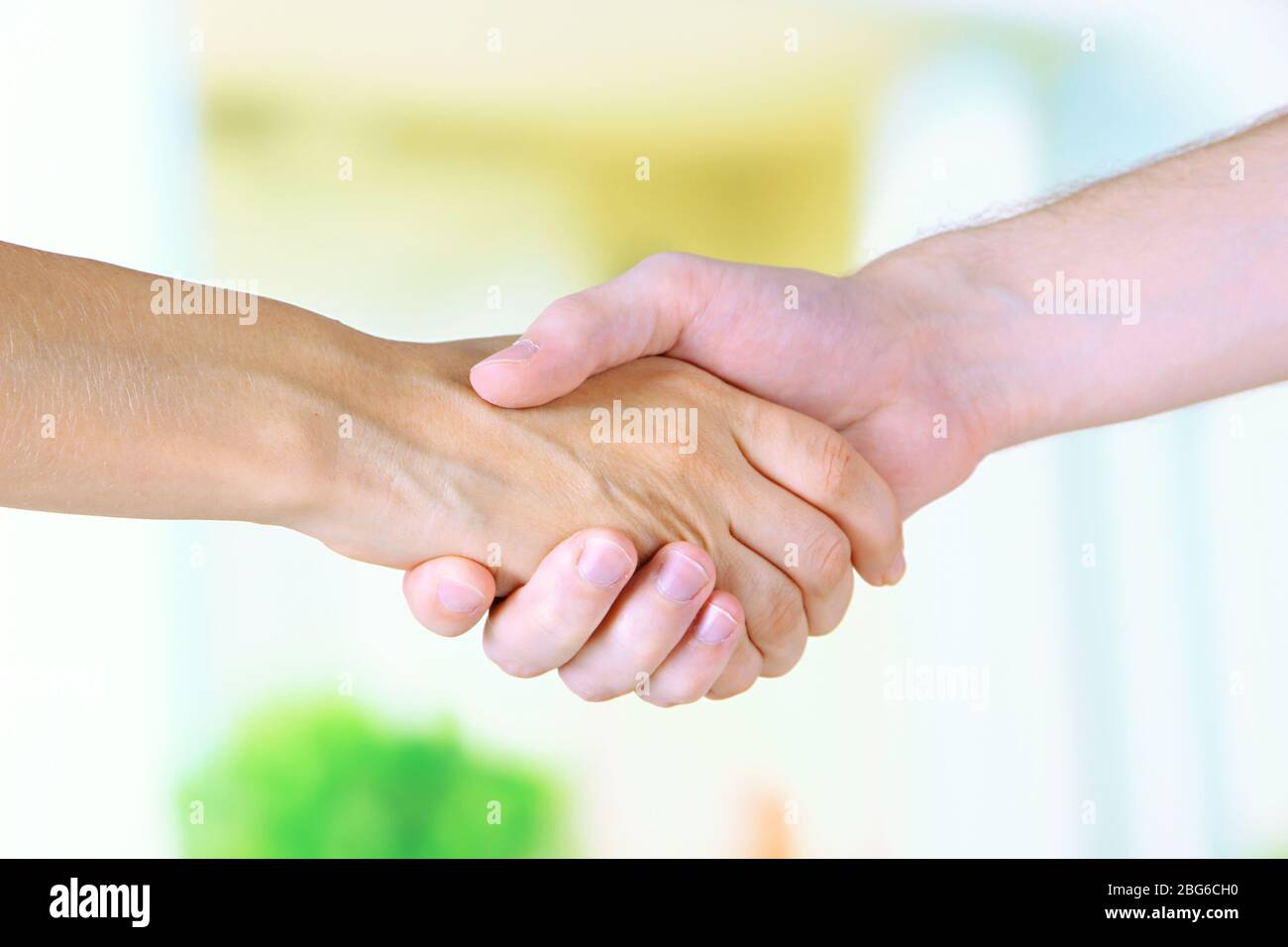 Friendly handshake on light blue hi-res stock photography and images ...