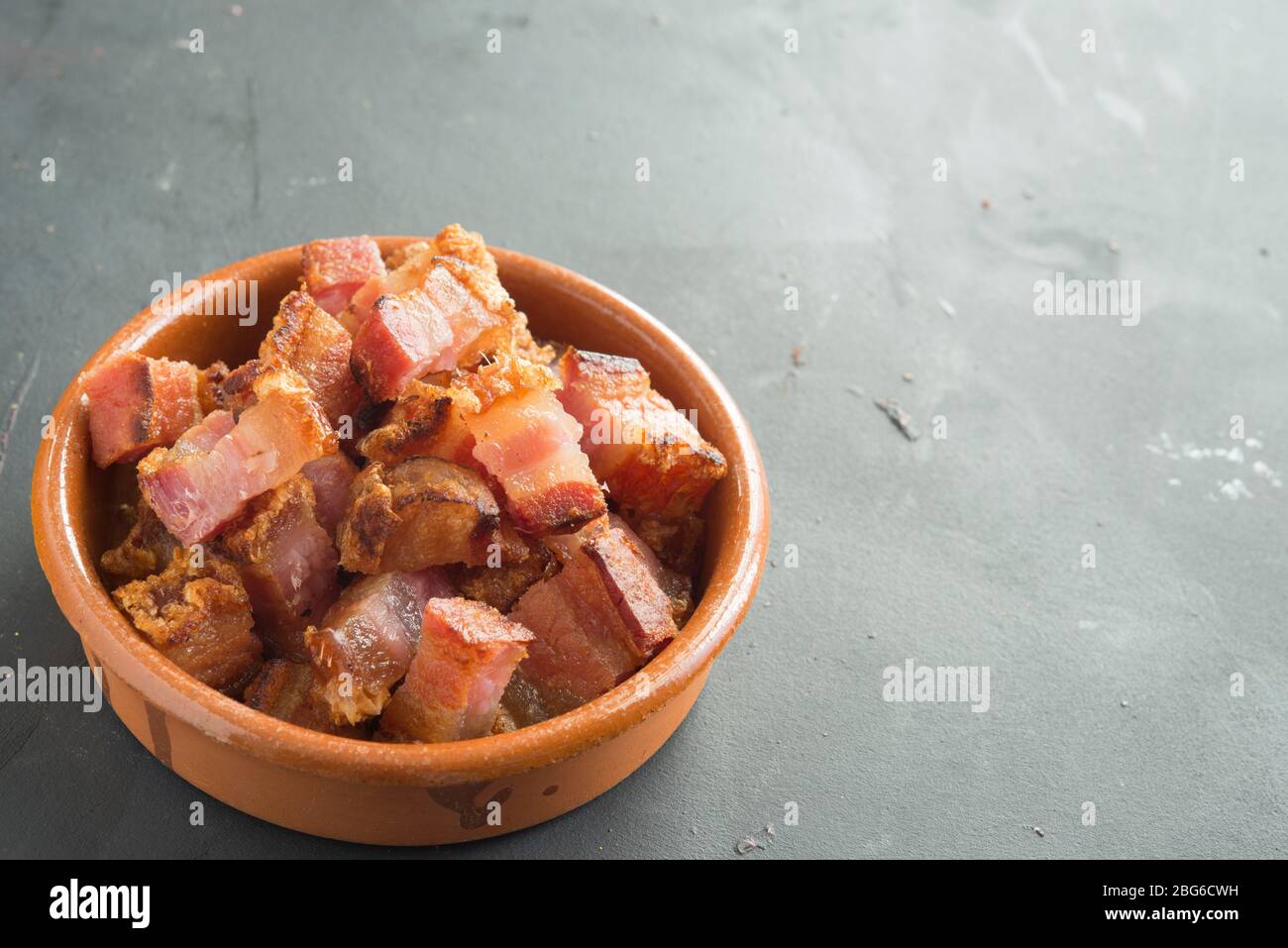slice of bacon tapa typical spanish food Stock Photo - Alamy