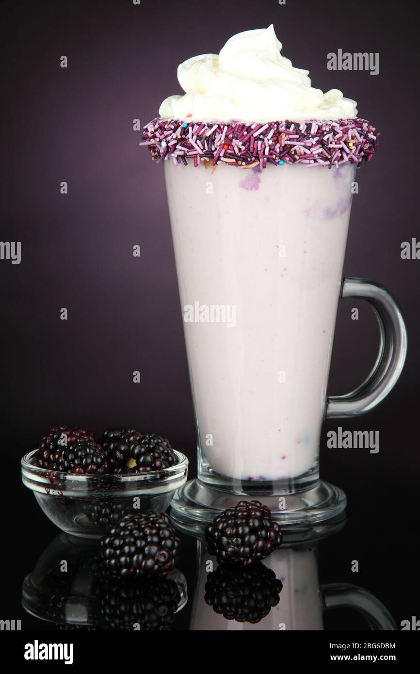 Delicious milk shake on dark purple background Stock Photo - Alamy