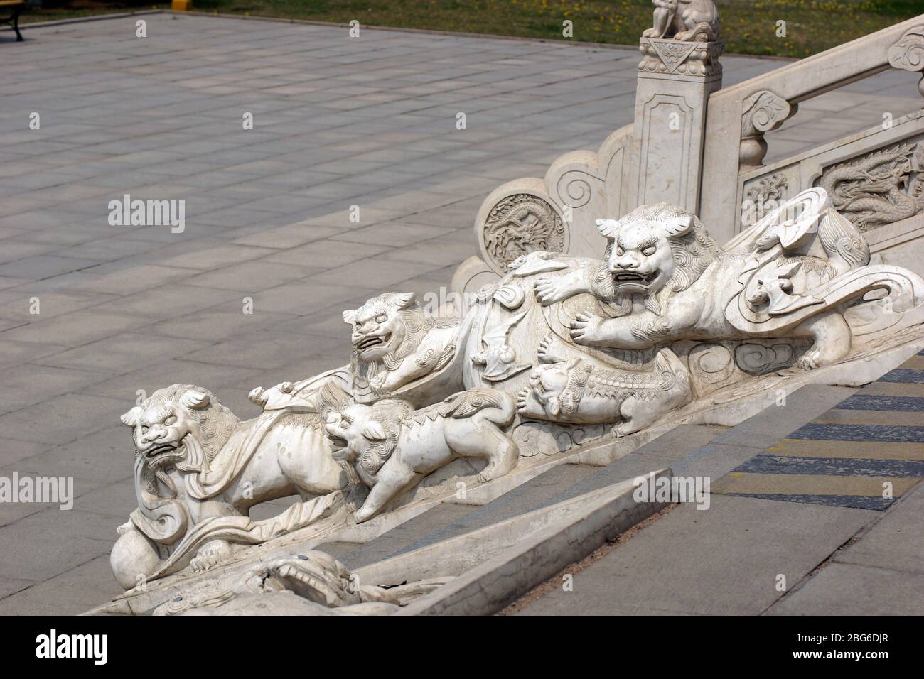 Chinese lions and bats are carved in stone. Jade Buddha Park, Anshan ...