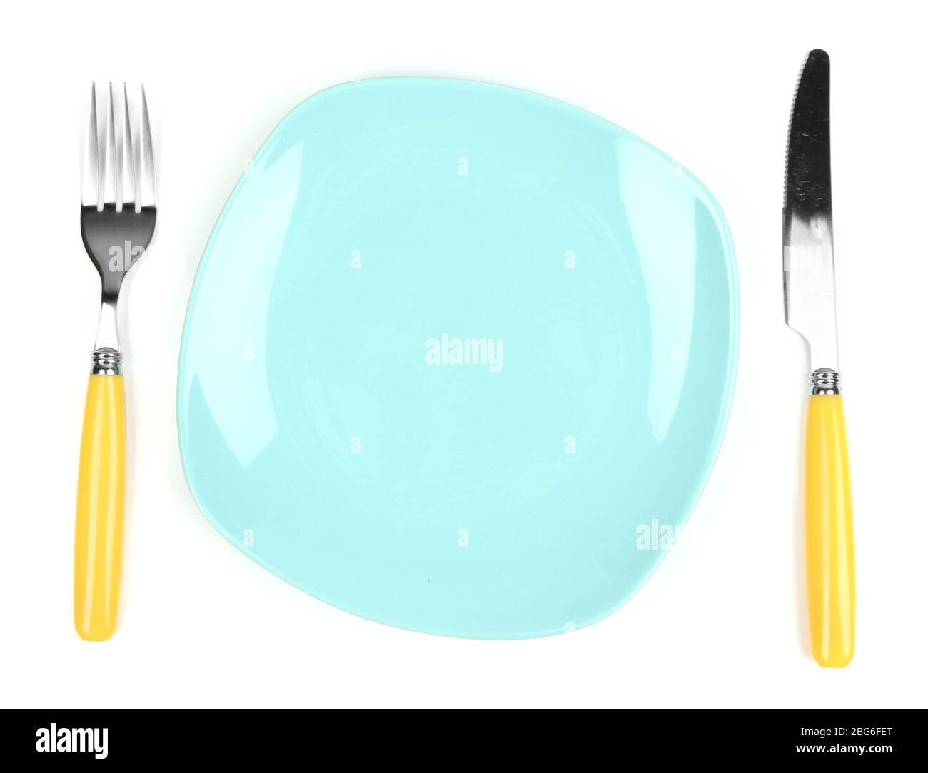 Knife, color plate and fork, isolated on white Stock Photo - Alamy