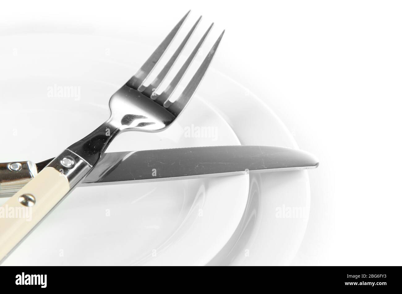 Knife, color plate and fork, isolated on white Stock Photo - Alamy