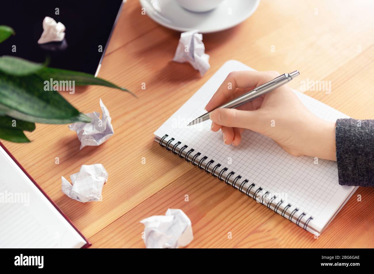 Workplace of writer, rewriter. Female hand holding pen and writing in ...