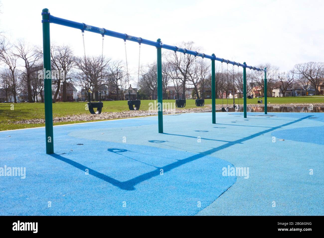 Empty swing set in public park Stock Photo - Alamy