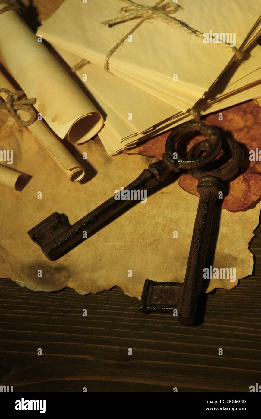 Antique keys and scroll on dark background Stock Photo - Alamy