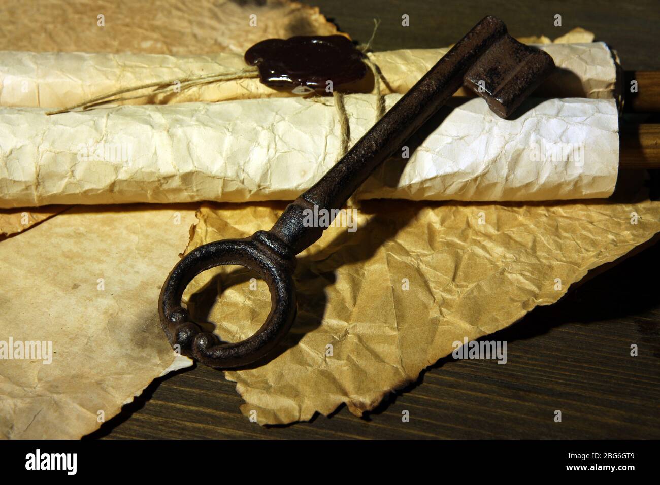 Antique key and scroll on dark background Stock Photo - Alamy