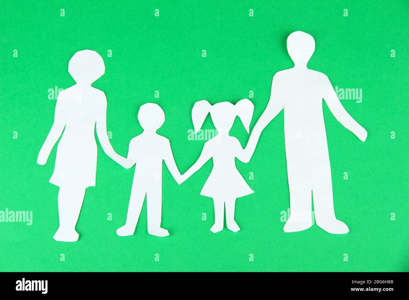 Family from paper on bright background Stock Photo - Alamy