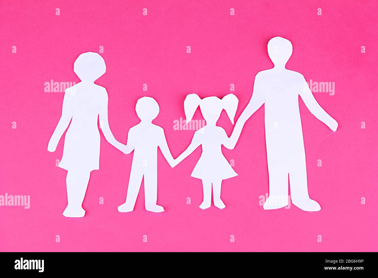 Family from paper on bright background Stock Photo - Alamy