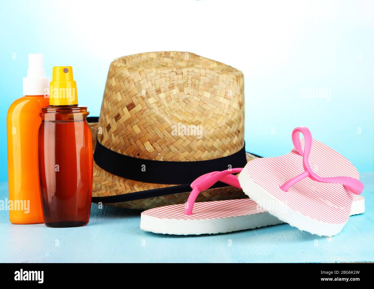 Beach items on beach background Stock Photo - Alamy