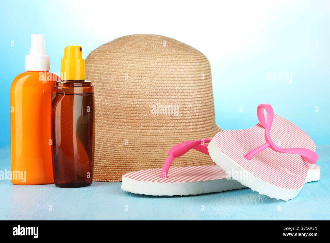 Beach items on beach background Stock Photo - Alamy
