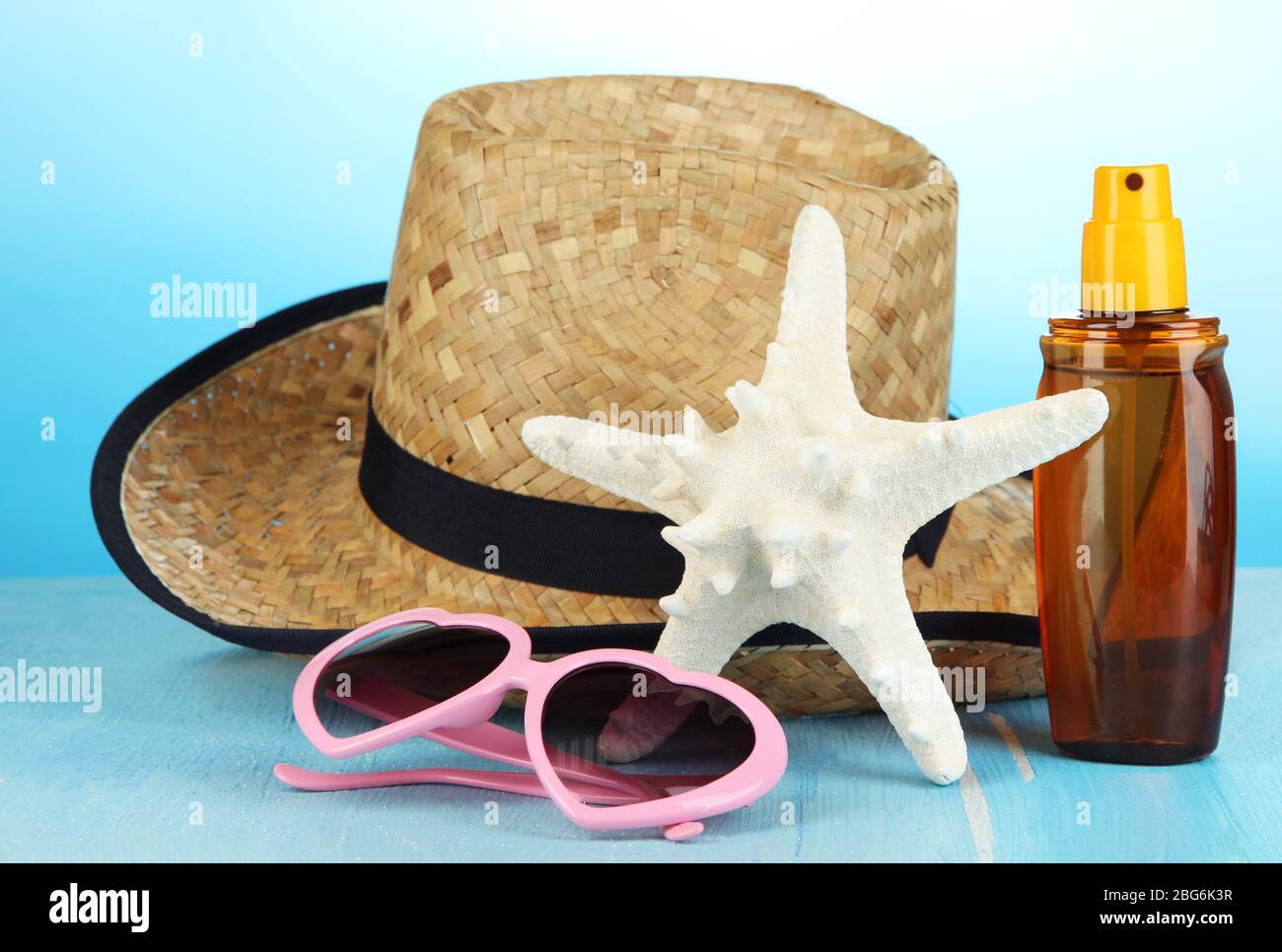 Beach items on beach background Stock Photo - Alamy