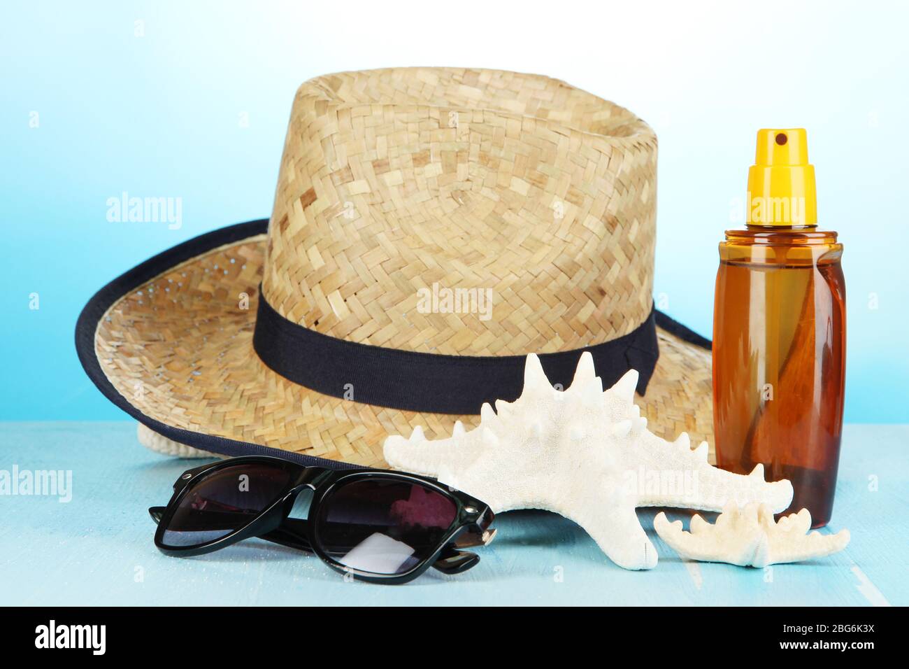 Beach items on beach background Stock Photo - Alamy