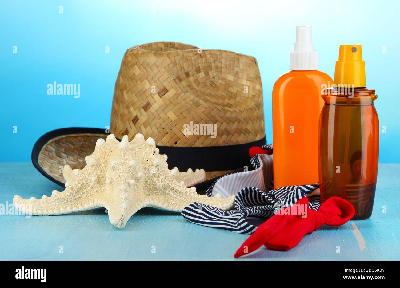 Beach items on beach background Stock Photo - Alamy
