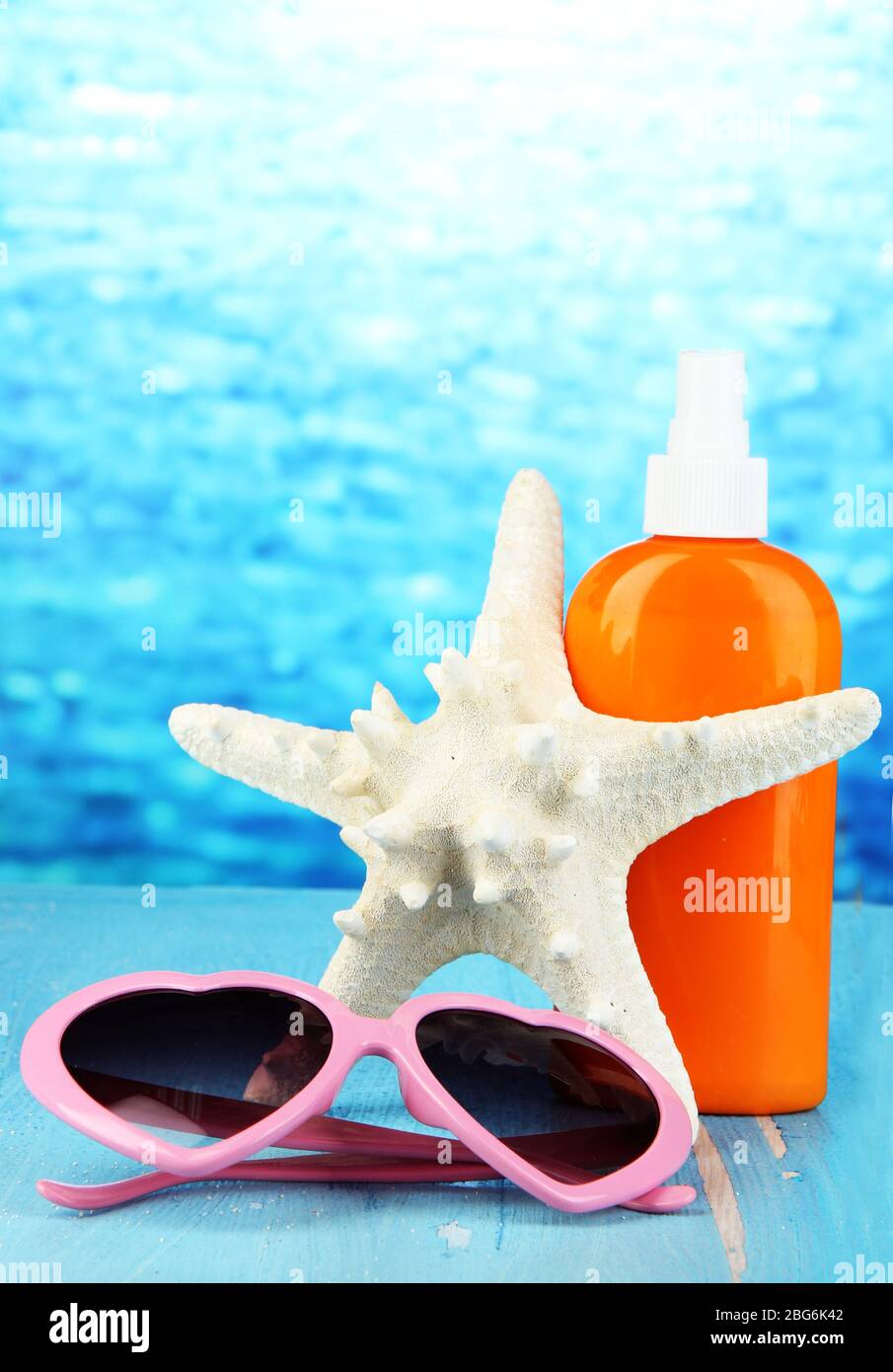 Beach items on beach background Stock Photo - Alamy