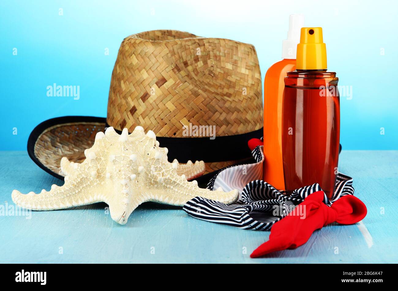 Beach items on beach background Stock Photo - Alamy