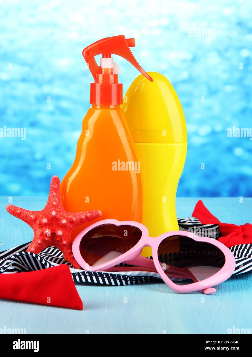 Beach items on beach background Stock Photo - Alamy