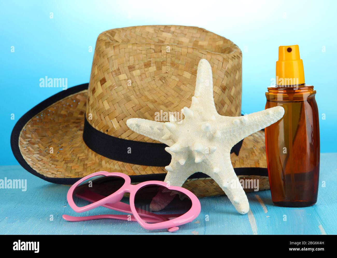 Beach items on beach background Stock Photo - Alamy