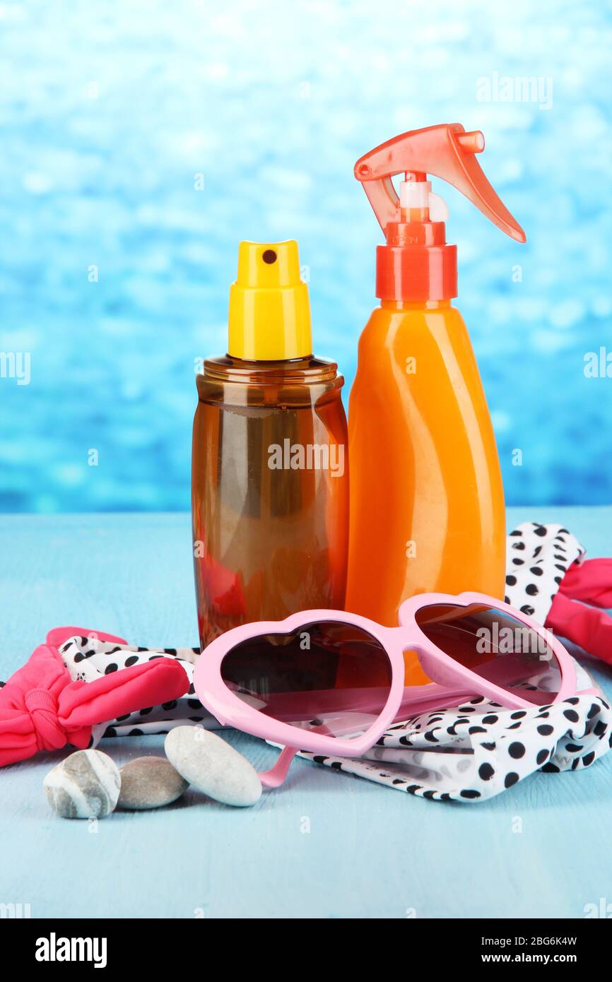 Beach items on beach background Stock Photo - Alamy