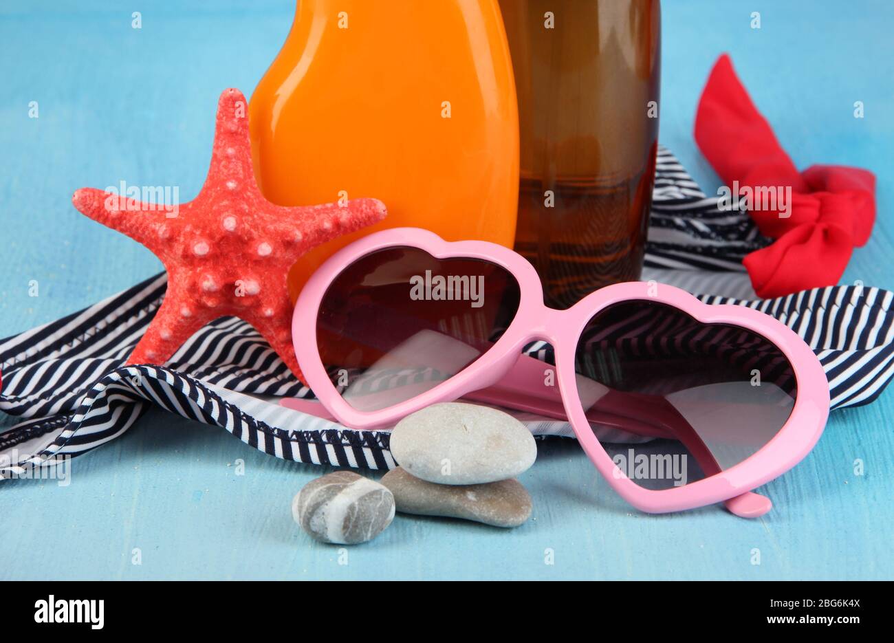 Beach items on beach background Stock Photo - Alamy