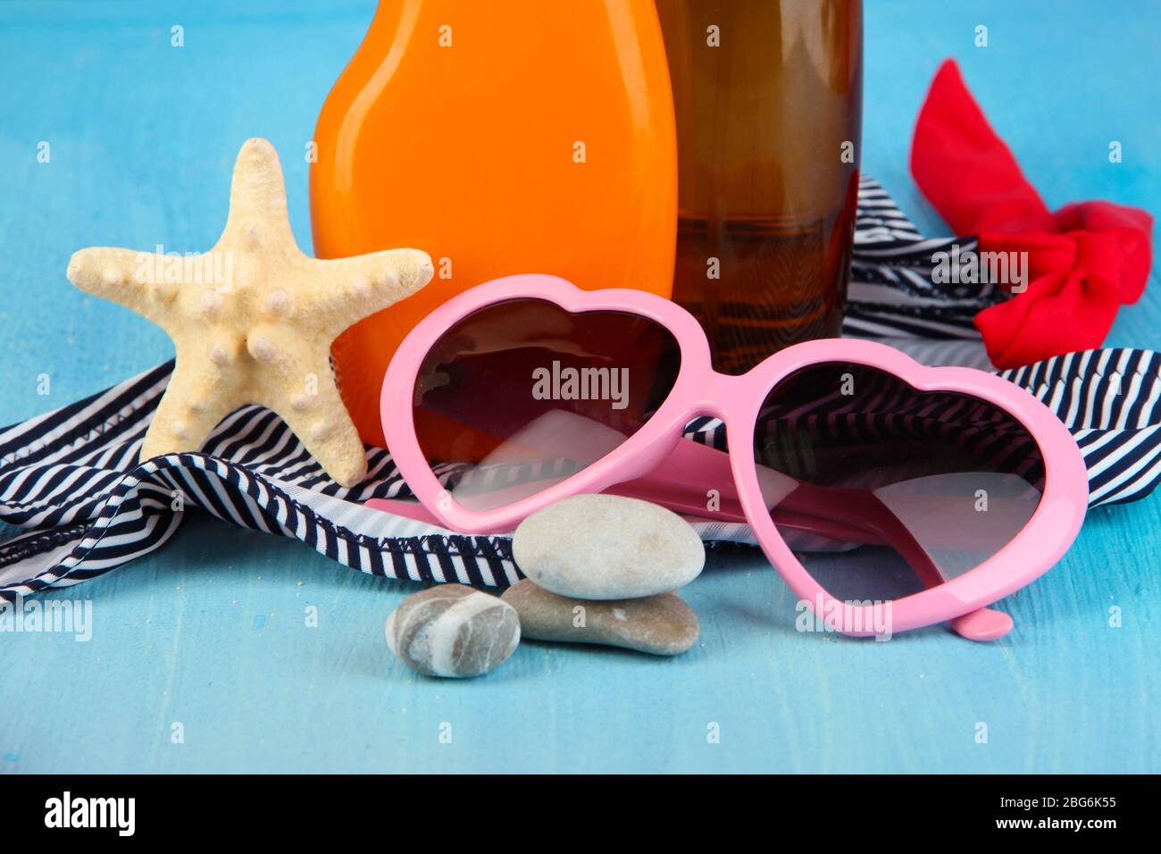 Beach items on beach background Stock Photo - Alamy