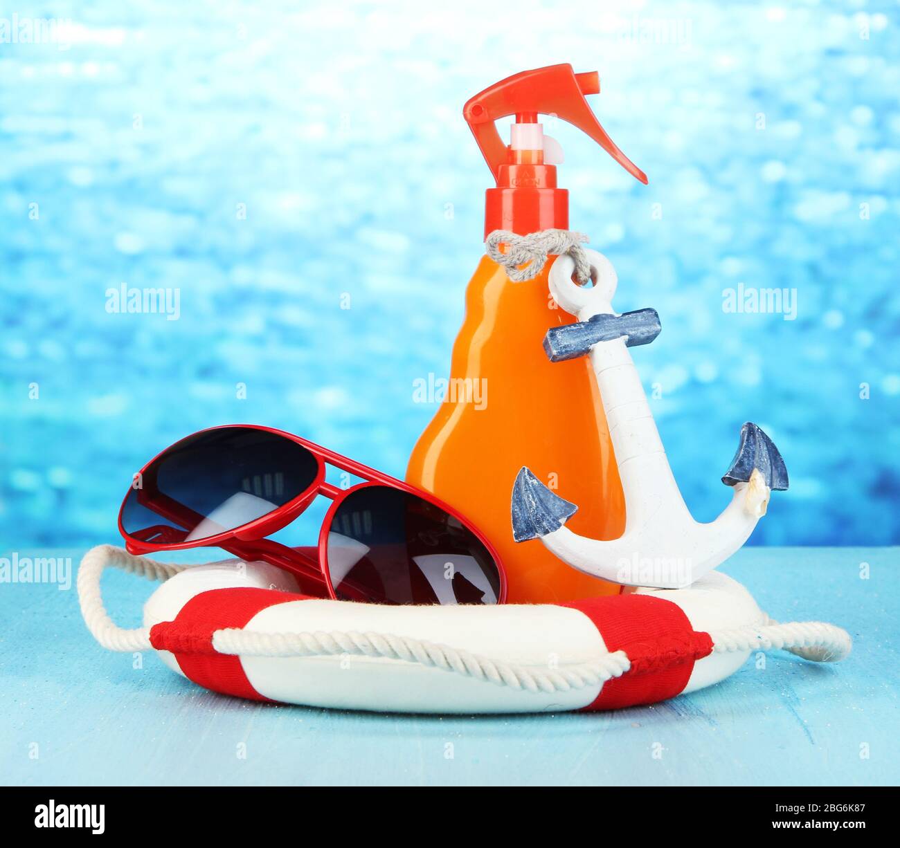 Beach items on beach background Stock Photo - Alamy