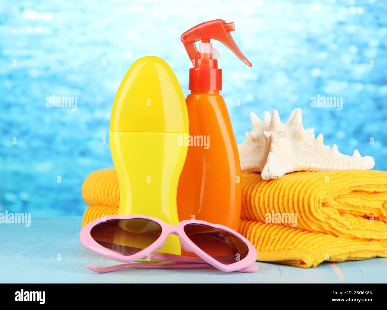 Beach items on beach background Stock Photo - Alamy