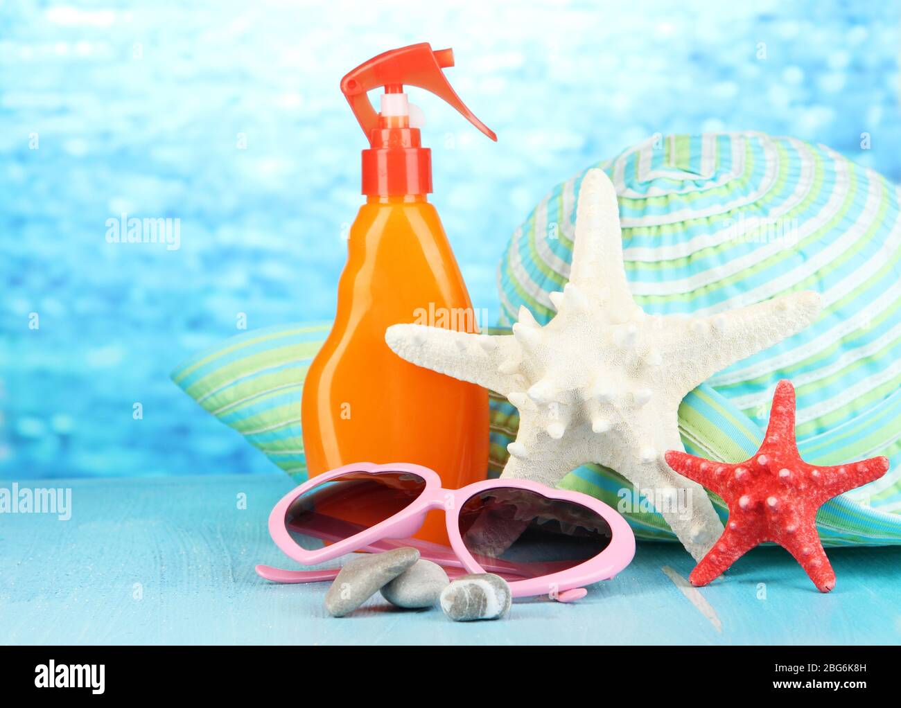 Beach items on beach background Stock Photo - Alamy