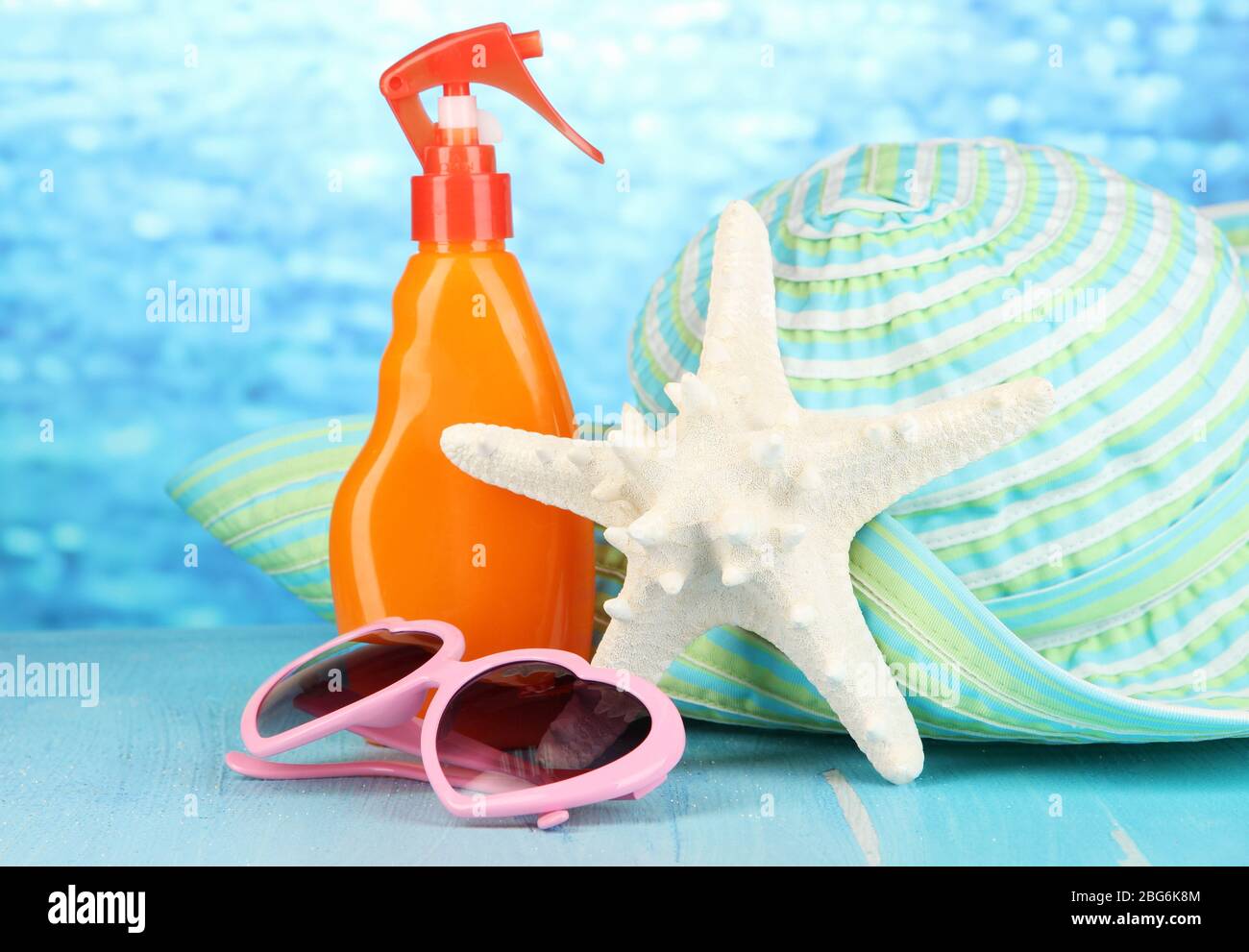 Beach items on beach background Stock Photo - Alamy