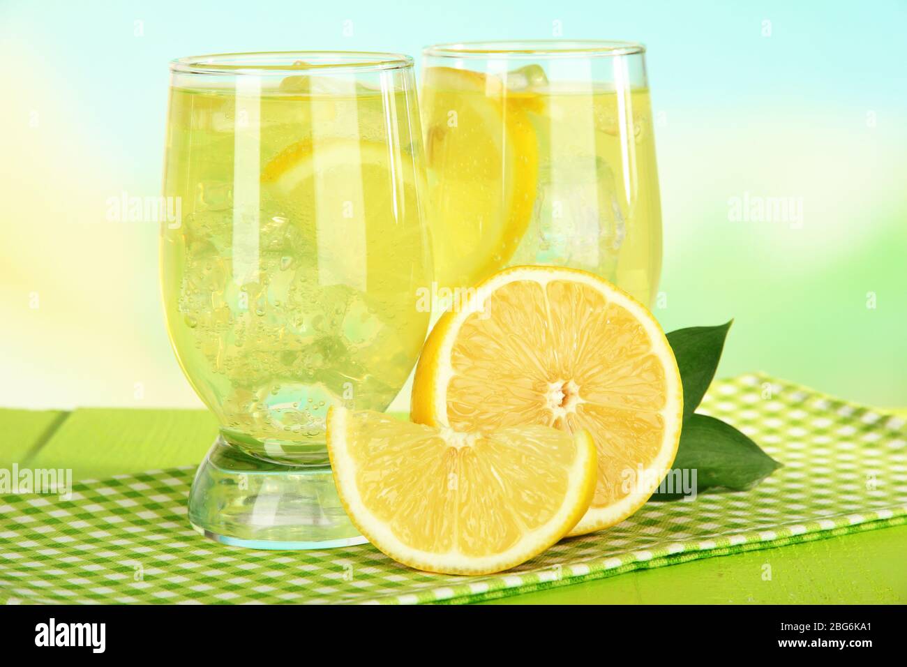 Delicious lemonade on table on light blue background Stock Photo - Alamy