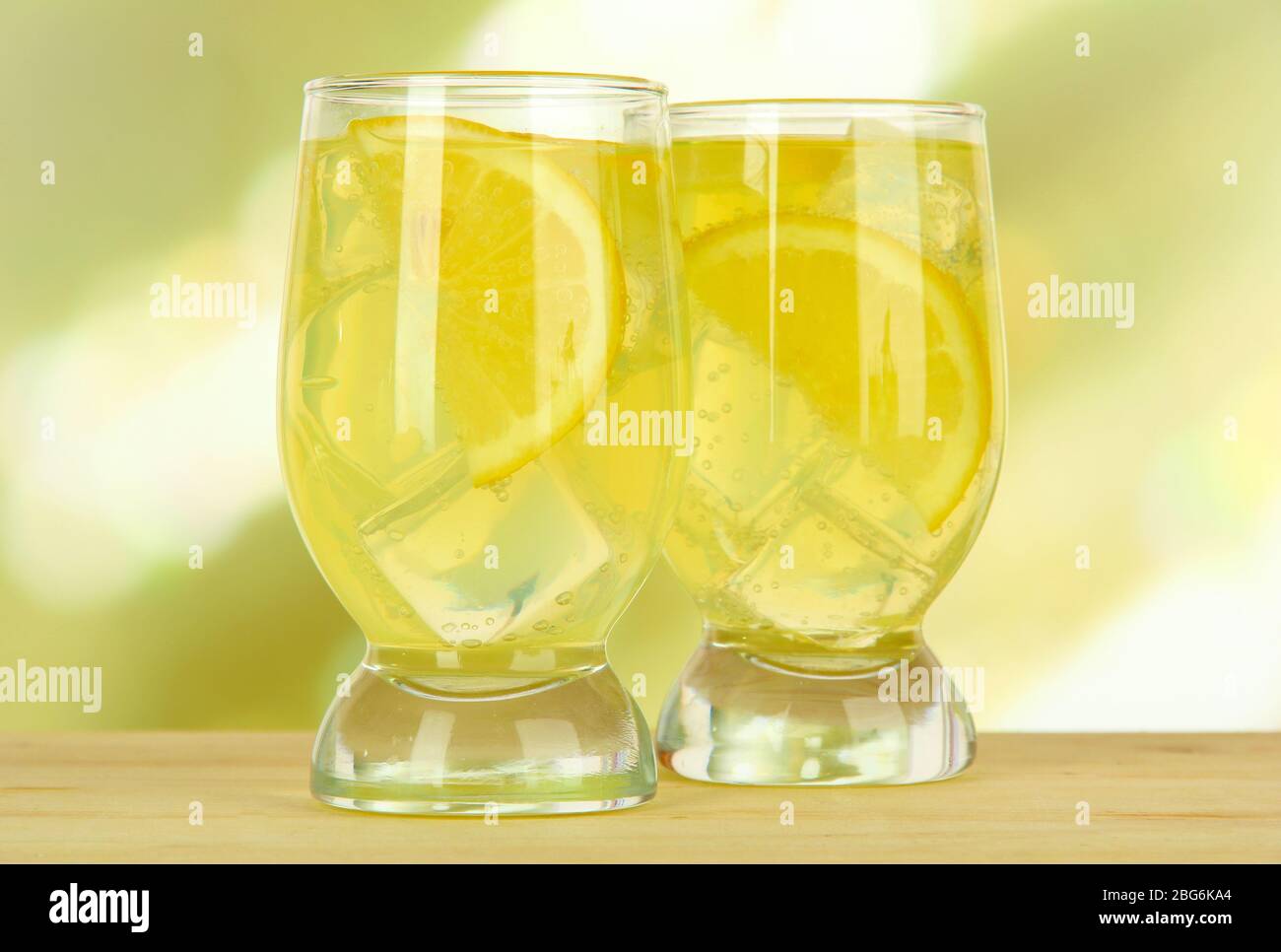 Delicious lemonade on table on light background Stock Photo - Alamy