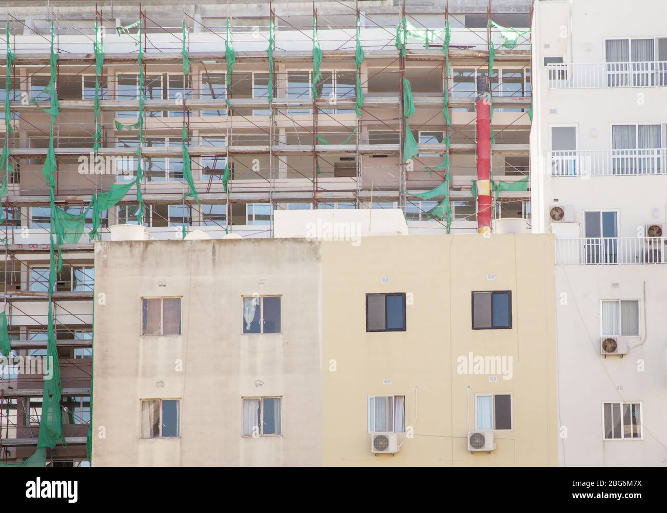 looking up at the open side of a building being build without its walls ...