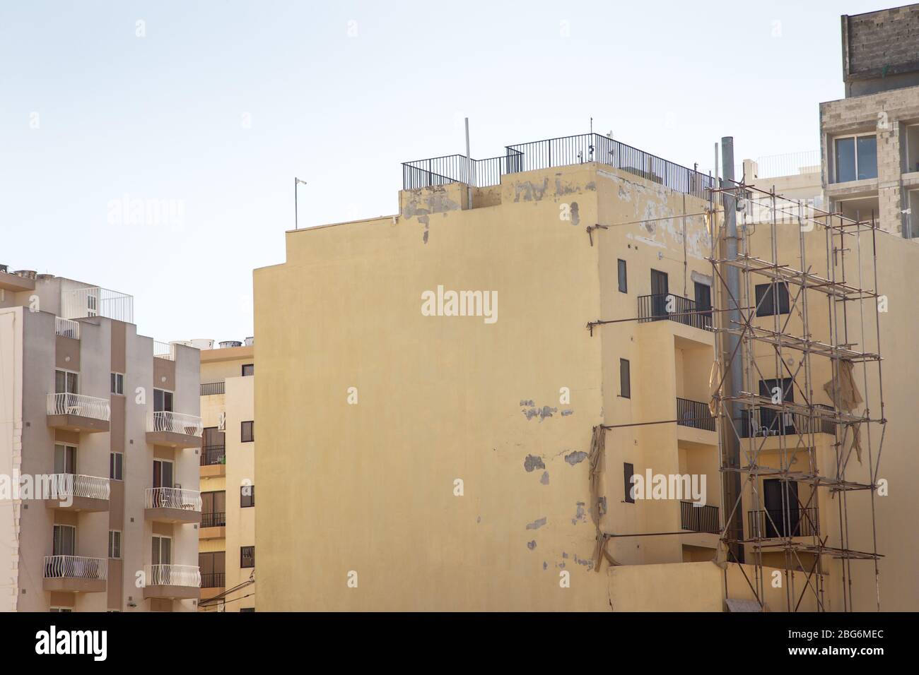 looking up at the open side of a building being build without its walls ...