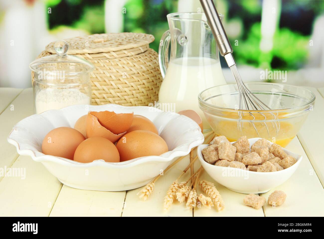 Ingredients for dough on wooden table on window background Stock Photo ...