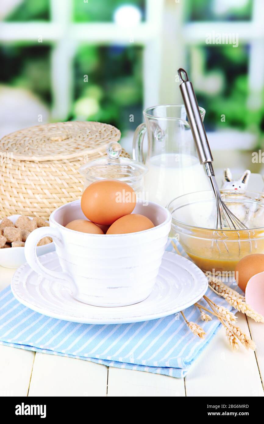 Ingredients for dough on wooden table on window background Stock Photo ...