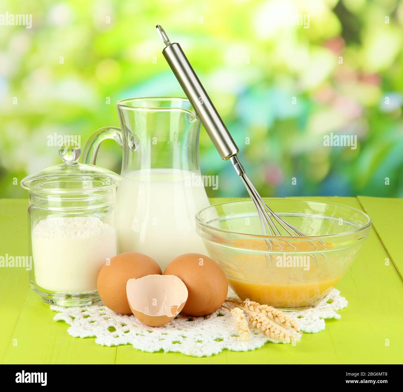 Ingredients for dough on wooden table on natural background Stock Photo ...