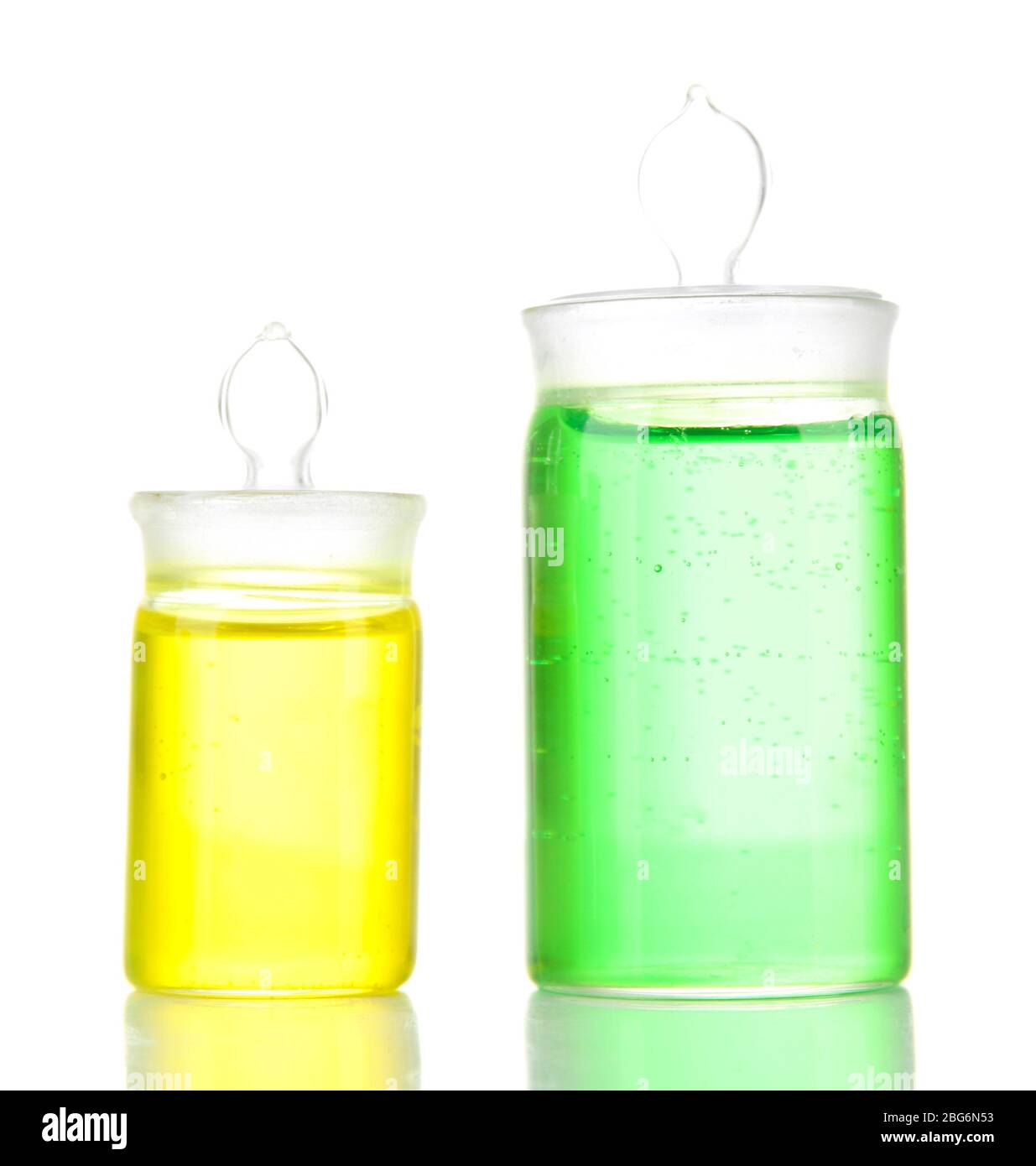 Bottles with colored liquids isolated on white Stock Photo - Alamy