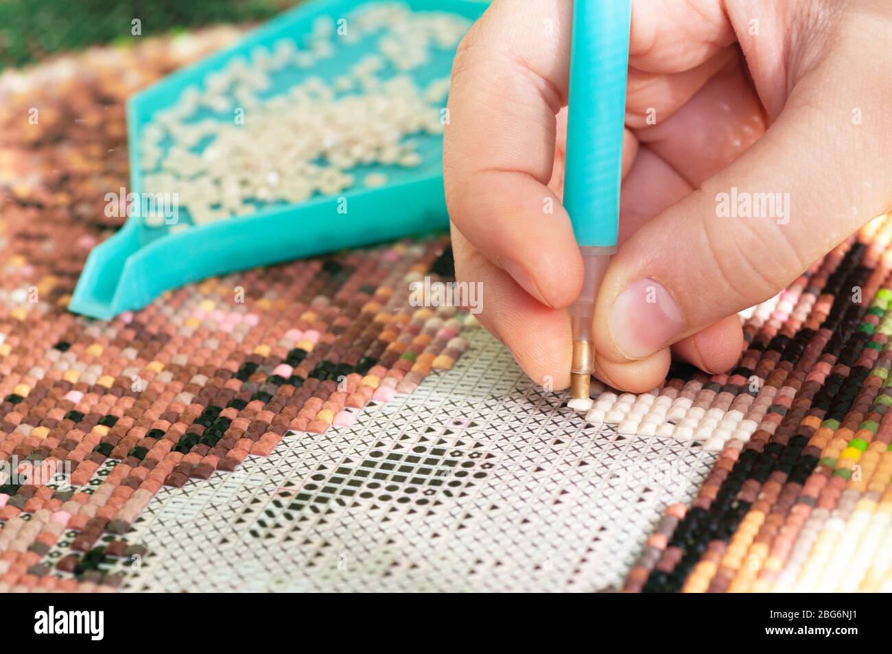 Collecting diamond embroidery, diamond mosaic. Colored crystals Stock ...