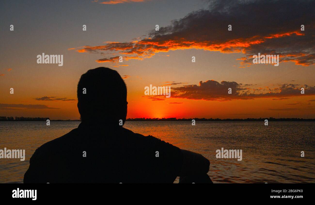 A man looking at sunset hi-res stock photography and images - Alamy