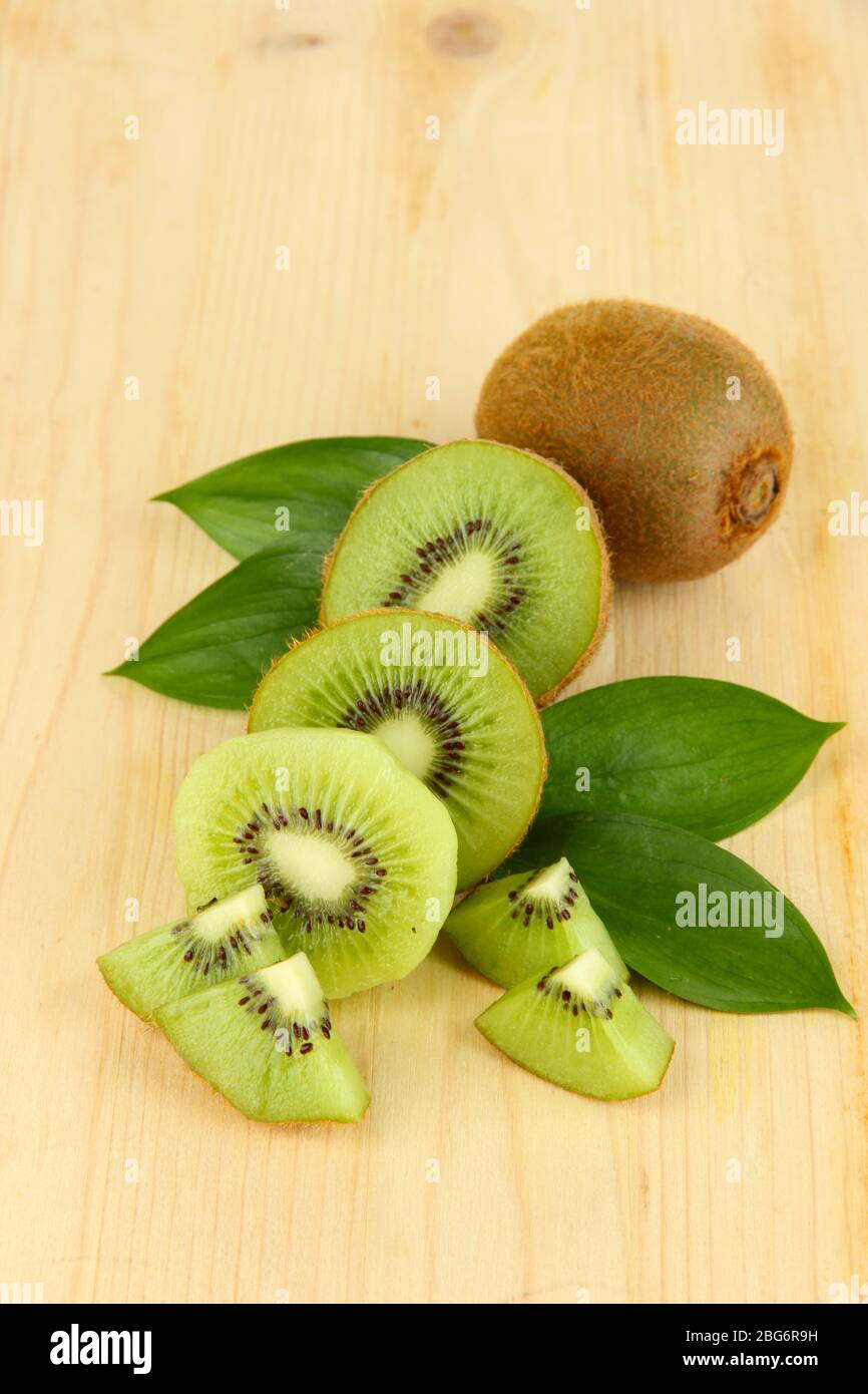 Ripe kiwi on wooden table close-up Stock Photo - Alamy
