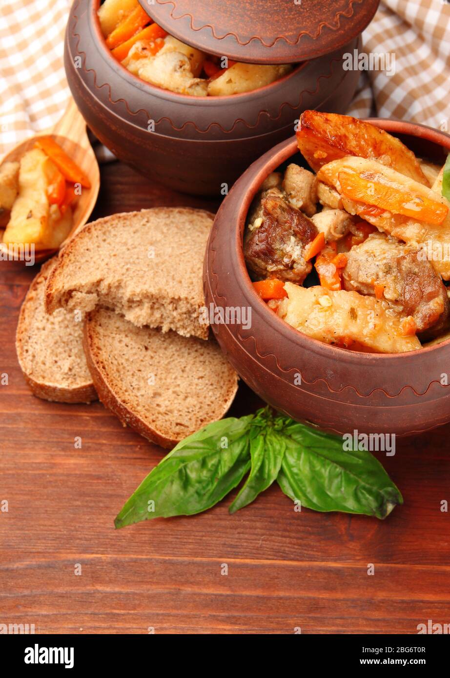 Homemade beef stir fry with vegetables in pots on wooden table, on ...
