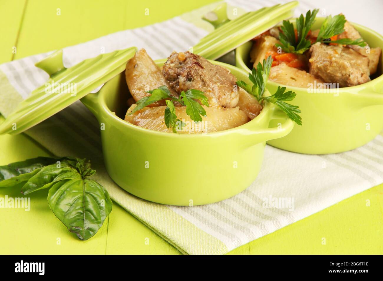 Homemade beef stir fry with vegetables in color pans, on bright ...